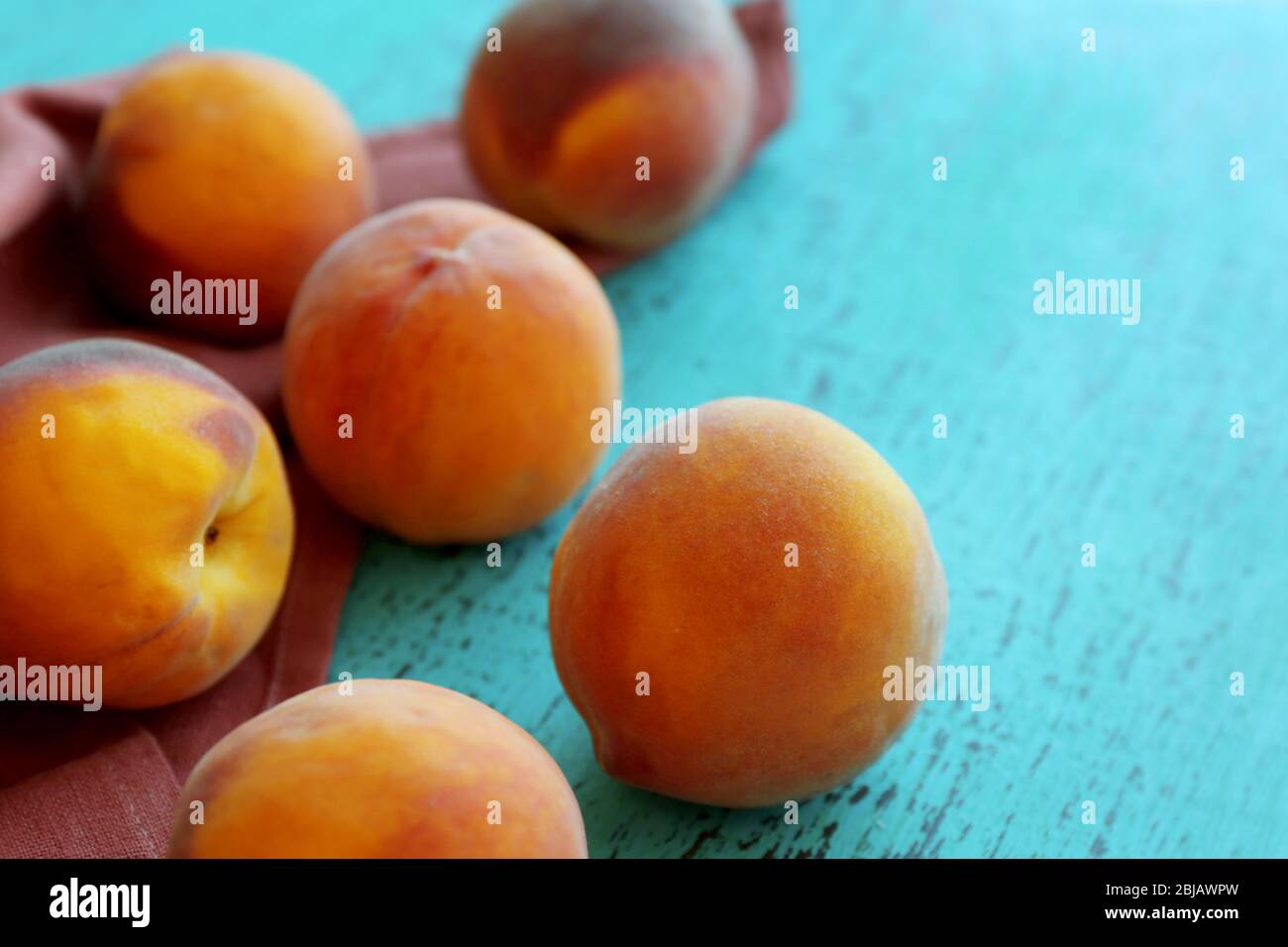 Fresh peaches on a color background Stock Photo - Alamy