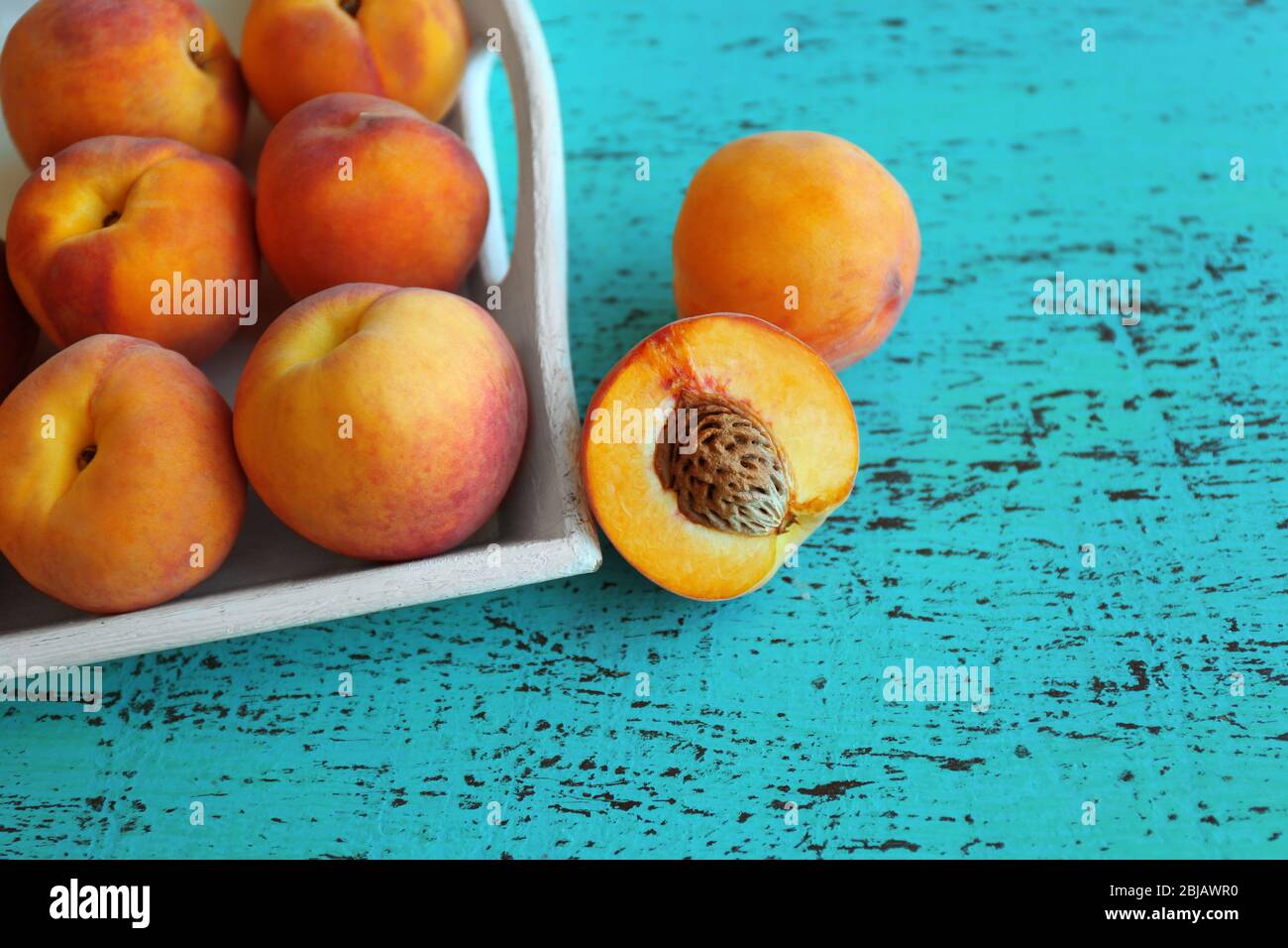 Fresh peaches on a color background Stock Photo - Alamy
