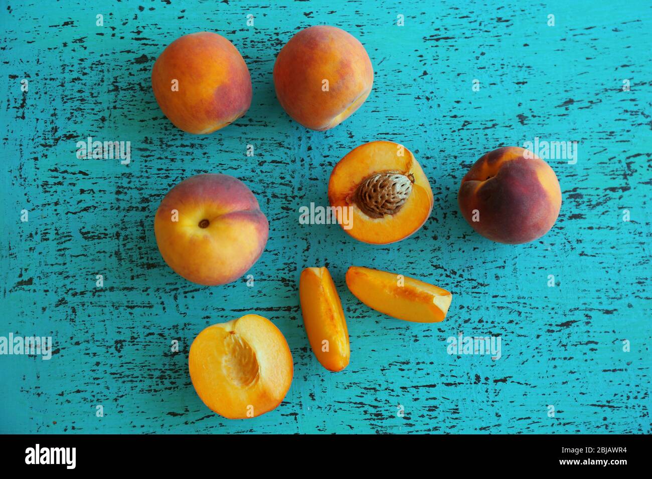 Fresh peaches on a color background Stock Photo - Alamy