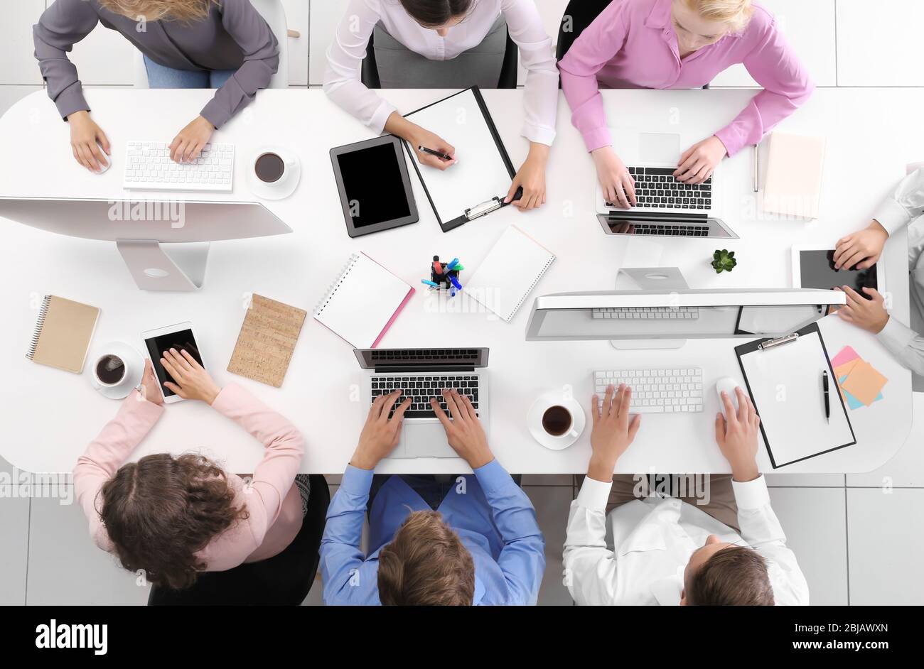 Group of people working on their computers and gadgets at office Stock ...