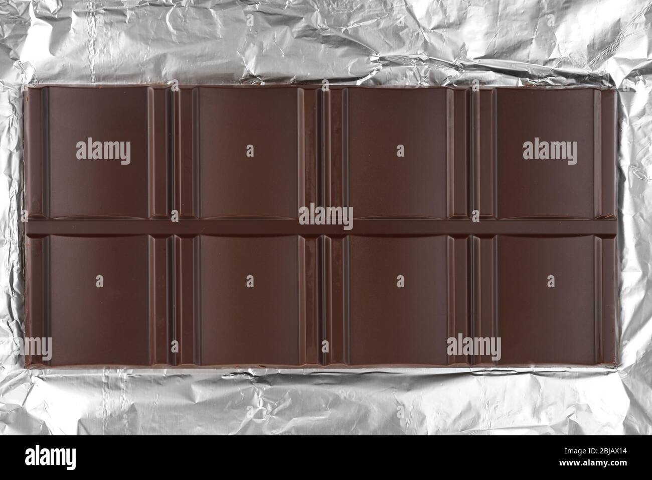 Chocolate bar on shiny silver foil Stock Photo - Alamy