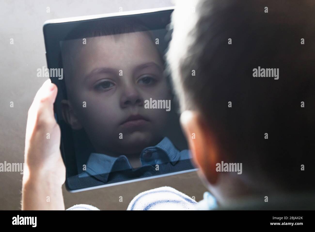 The child is learning distance learning lessons on a tablet. Home ...