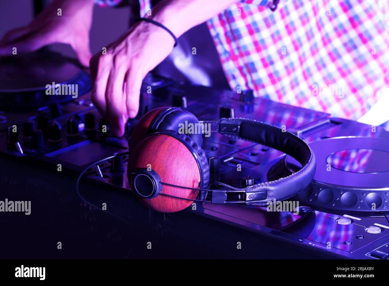 DJ mixing tracks on a mixer in a nightclub Stock Photo - Alamy