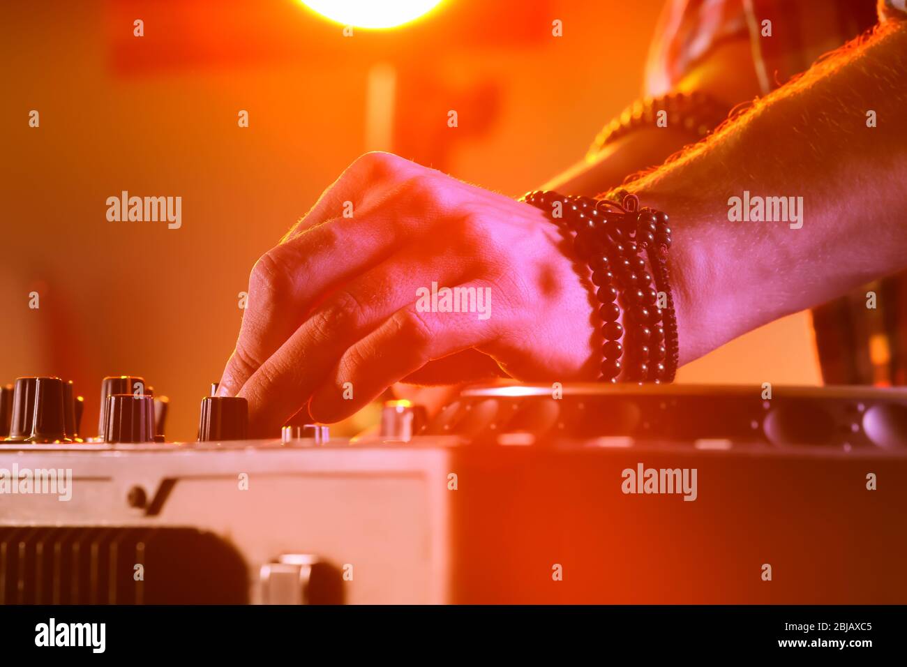 DJ mixing tracks on a mixer in a nightclub Stock Photo - Alamy
