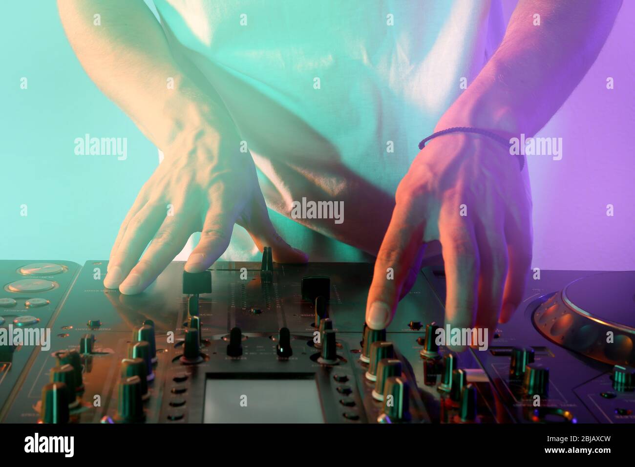 DJ mixing tracks on a mixer in a nightclub Stock Photo - Alamy