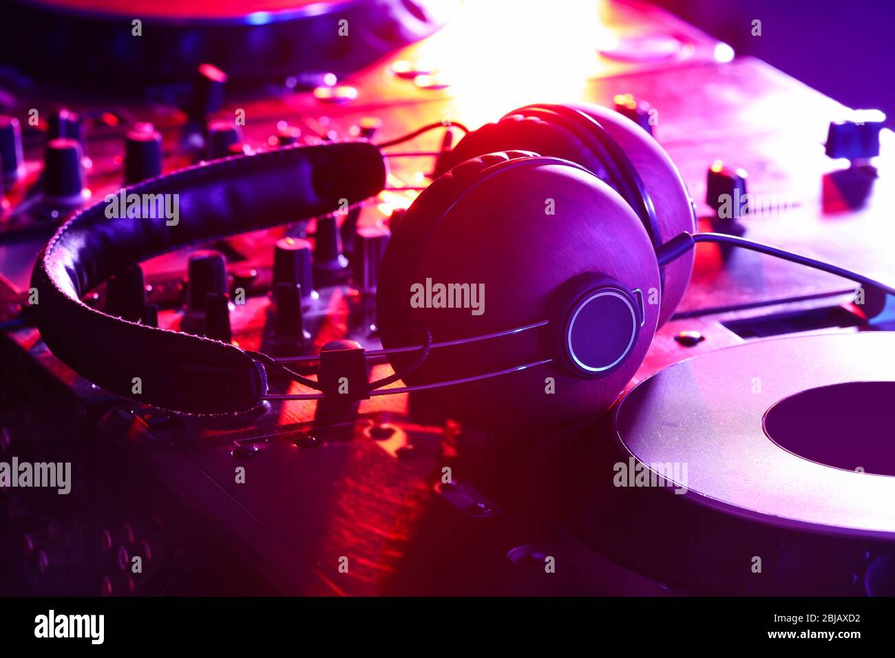 Headphones on dj mixer in nightclub Stock Photo - Alamy