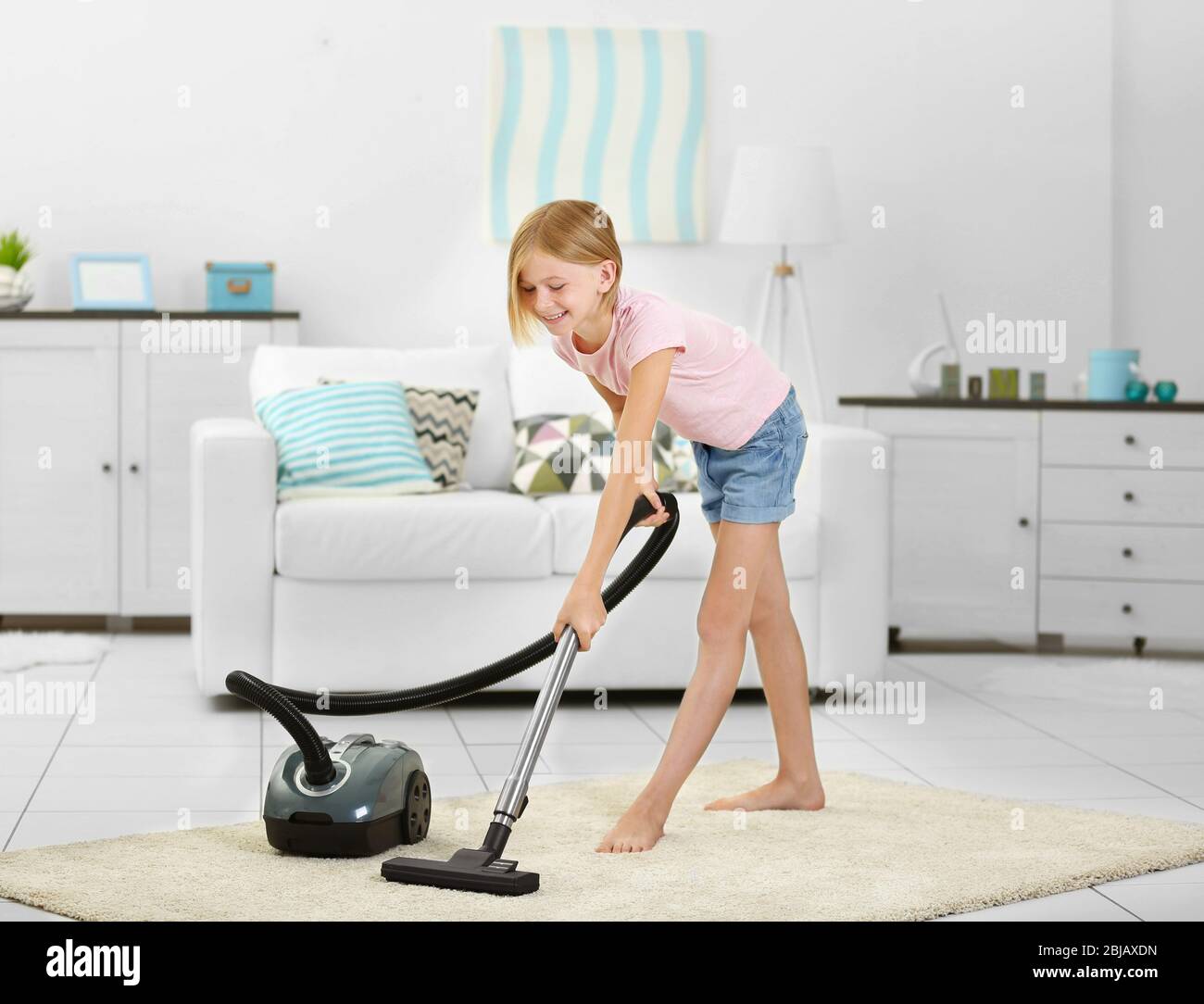 Little girl vacuuming floor with hoover Stock Photo - Alamy
