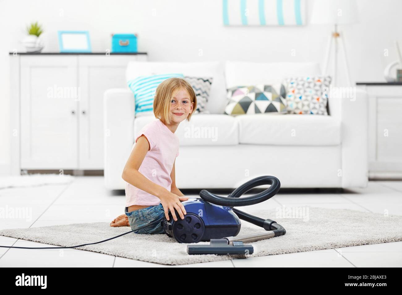 Little girl with hoover Stock Photo - Alamy