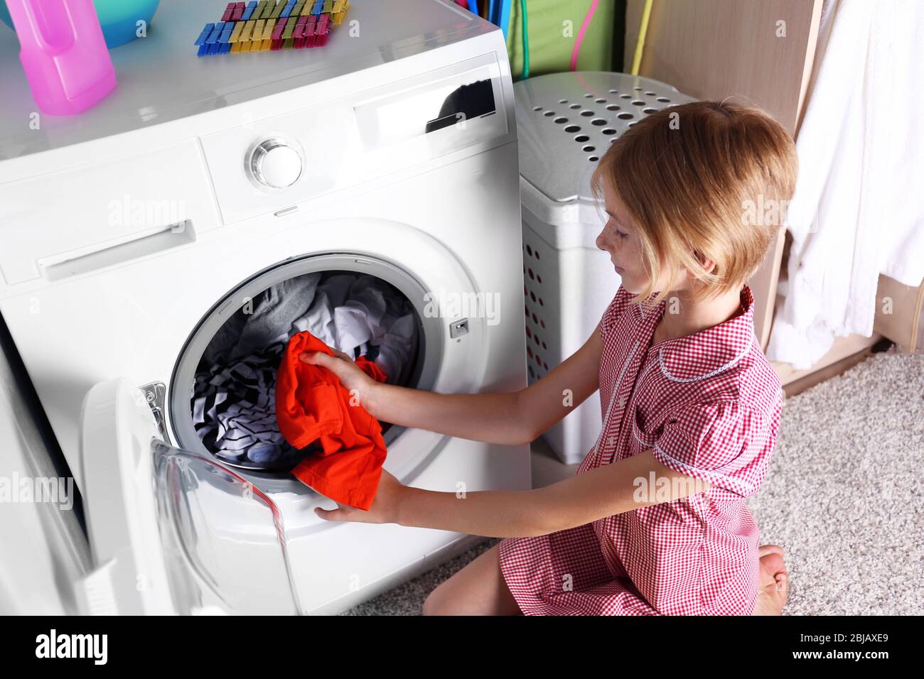 Girl washing clothes hi-res stock photography and images - Alamy