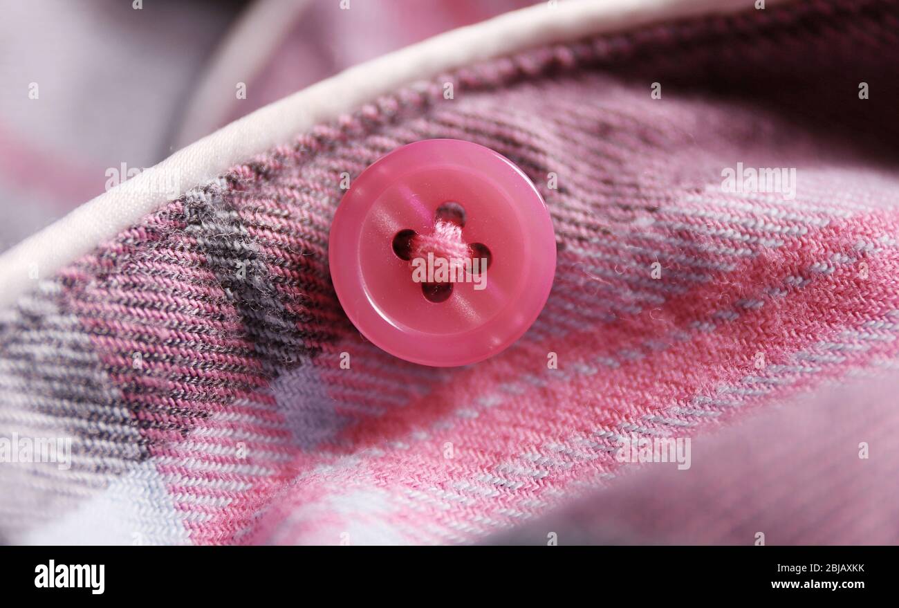 Button on a shirt close up Stock Photo - Alamy