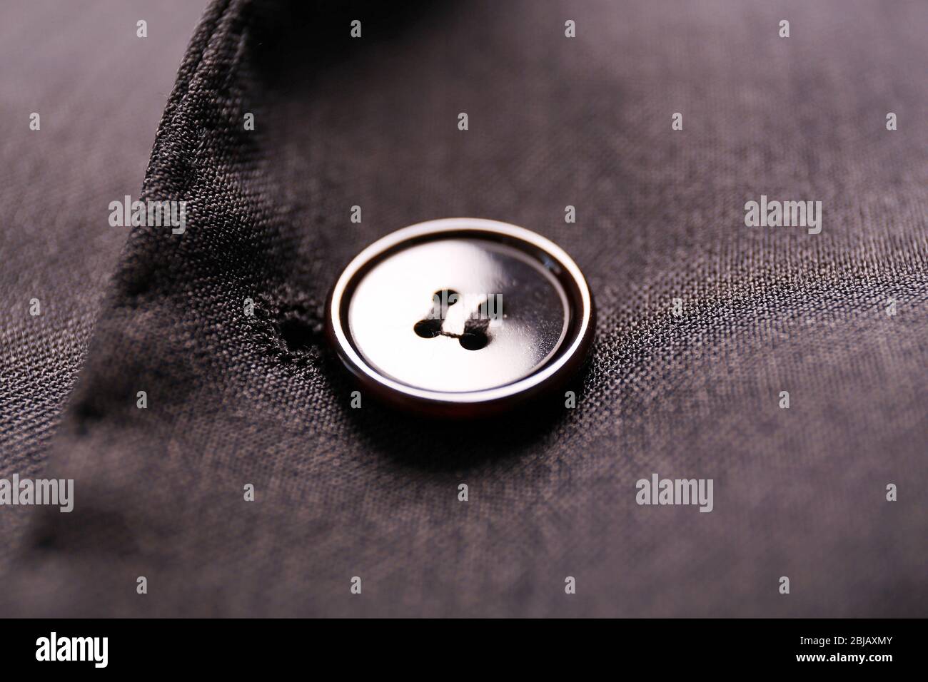 Button on a shirt close up Stock Photo - Alamy