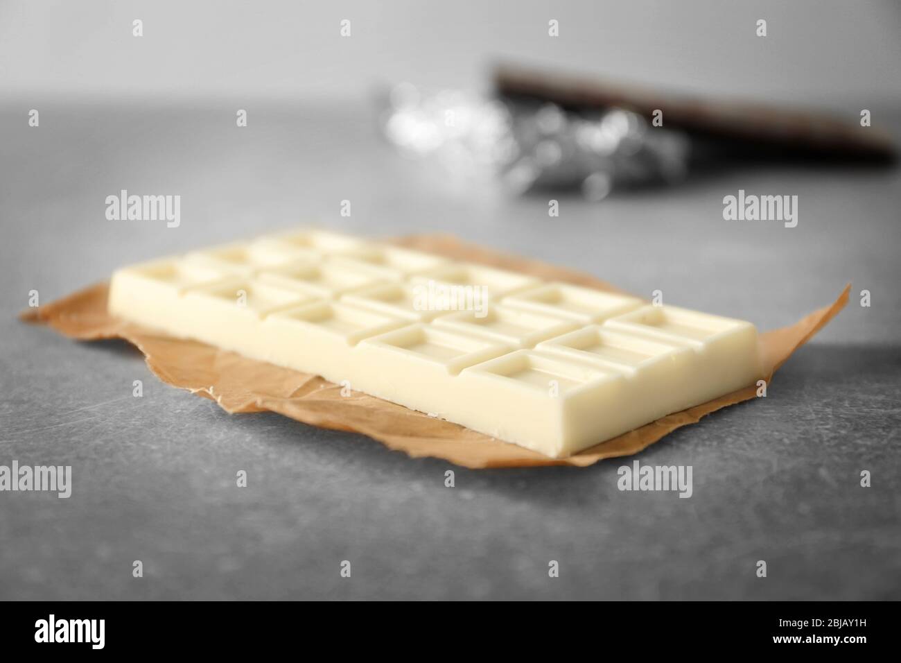 Chocolate bar on grey table Stock Photo - Alamy