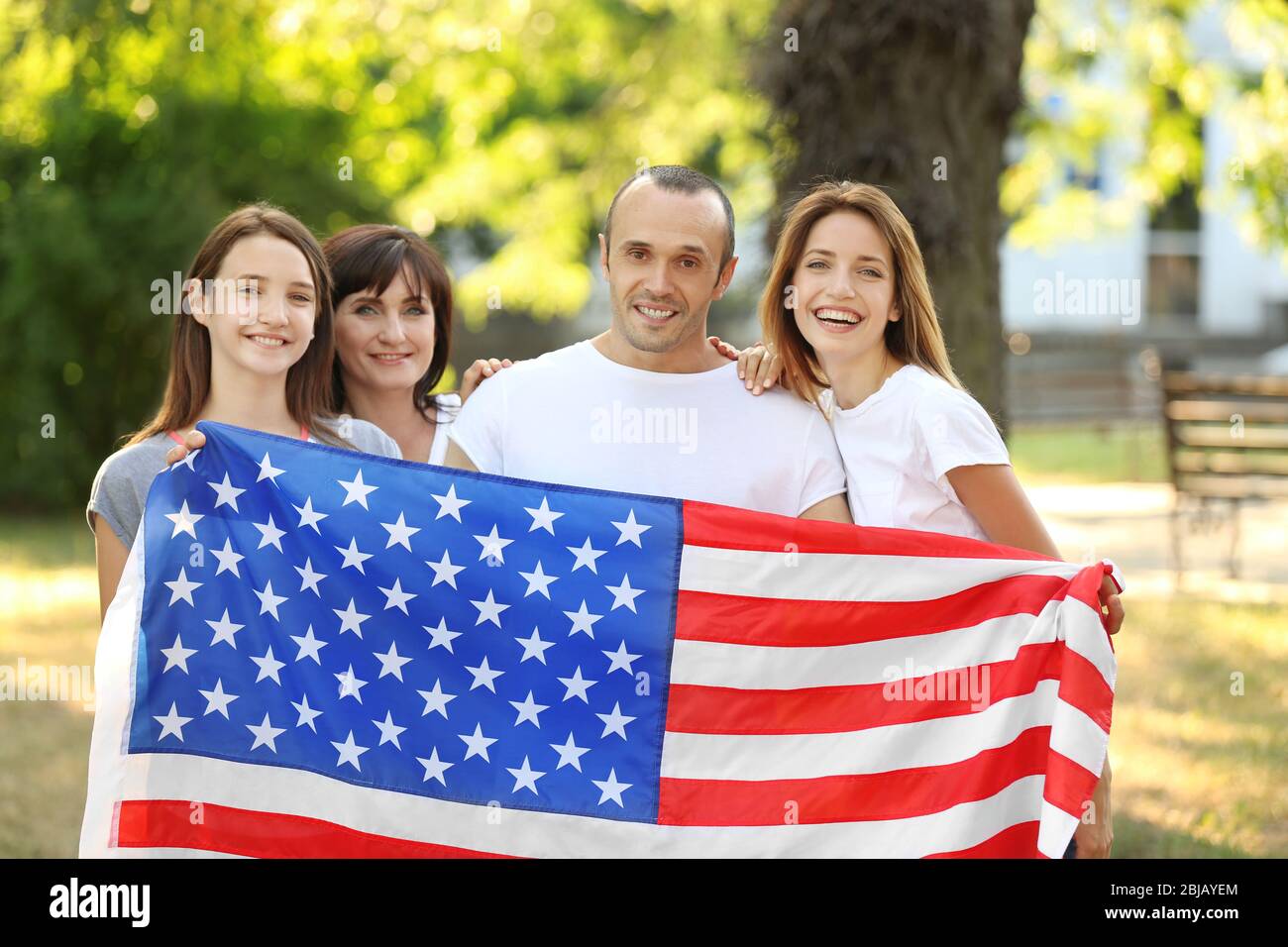 Modern family with USA flag outdoors Stock Photo - Alamy
