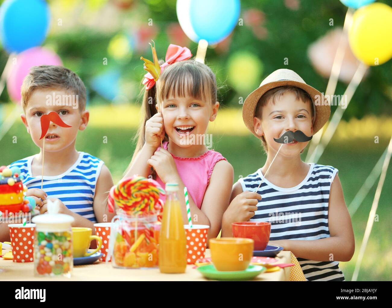 Children celebrating birthday in park Stock Photo - Alamy