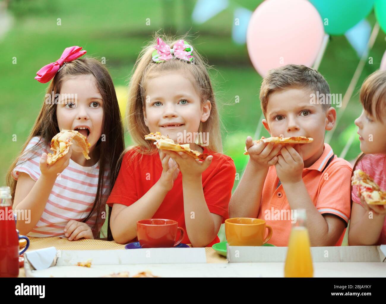 Children eating pizza in park Stock Photo - Alamy