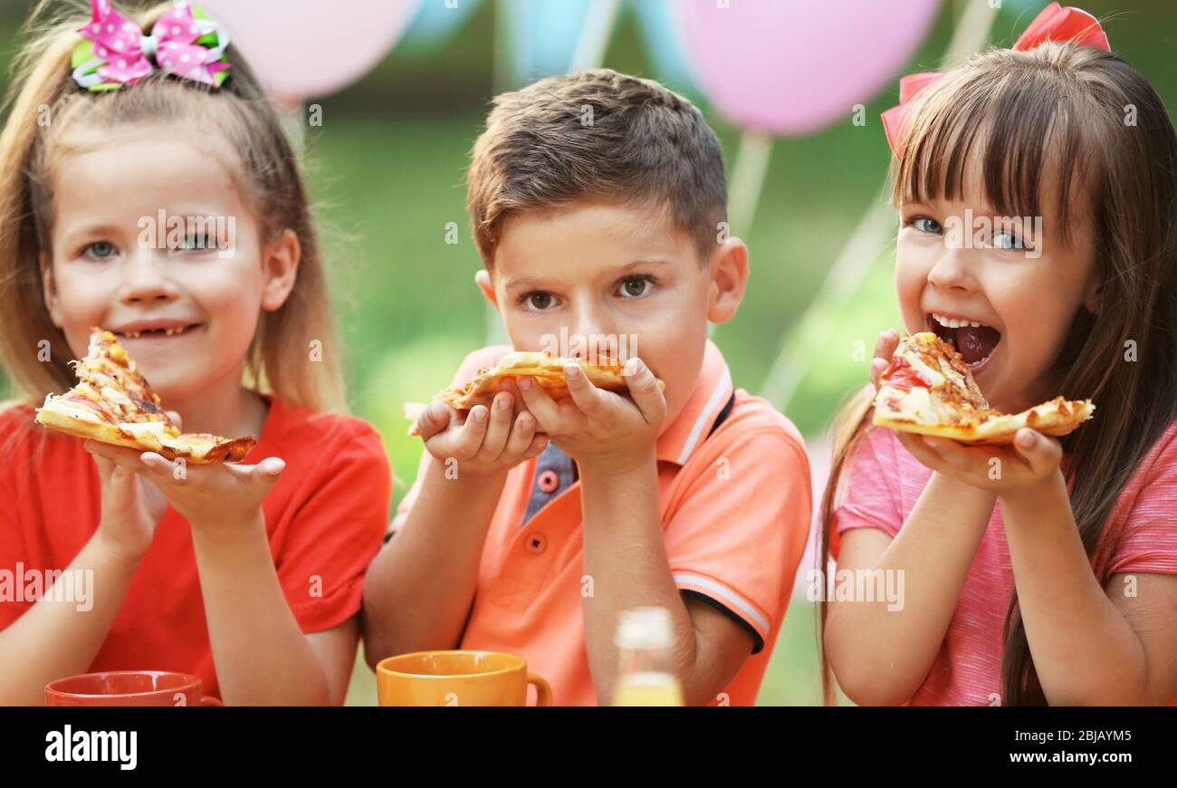 Children eating pizza in park Stock Photo - Alamy