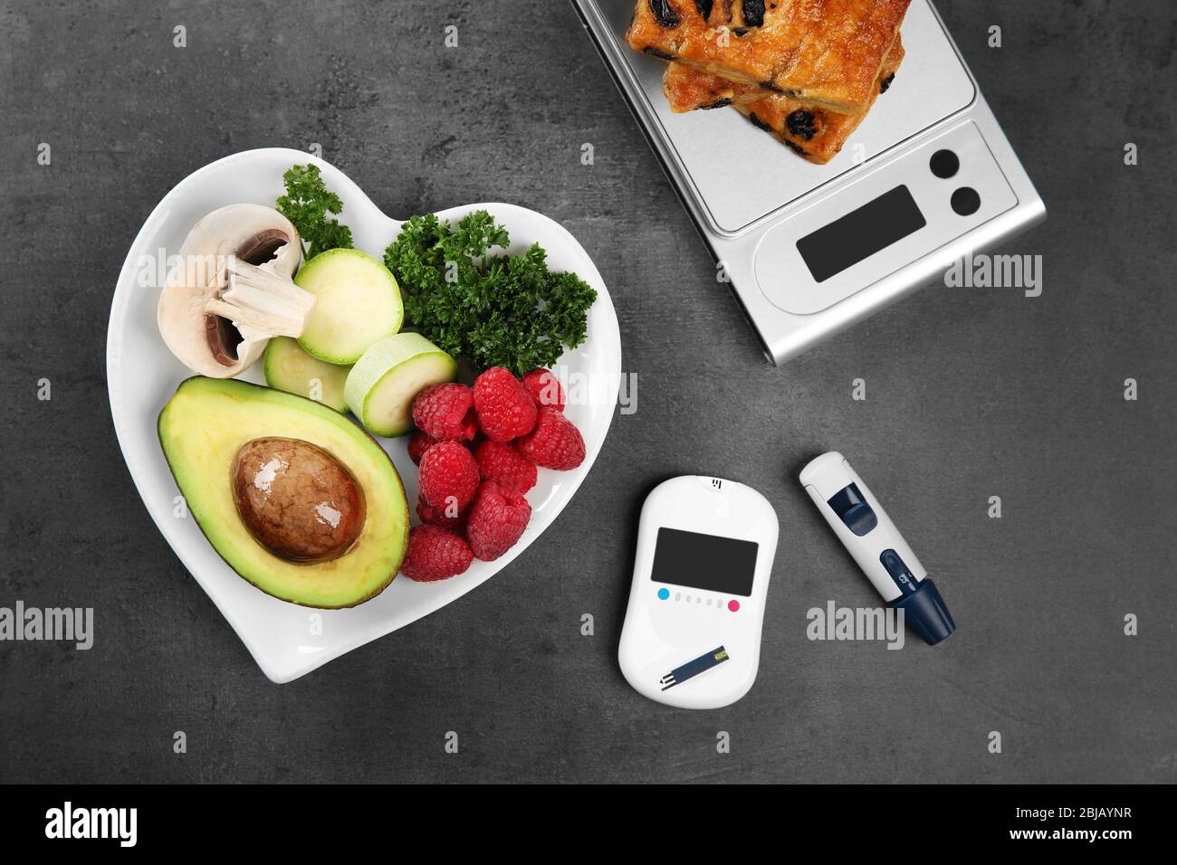 Glucose meter with healthy food and cookies on table Stock Photo - Alamy
