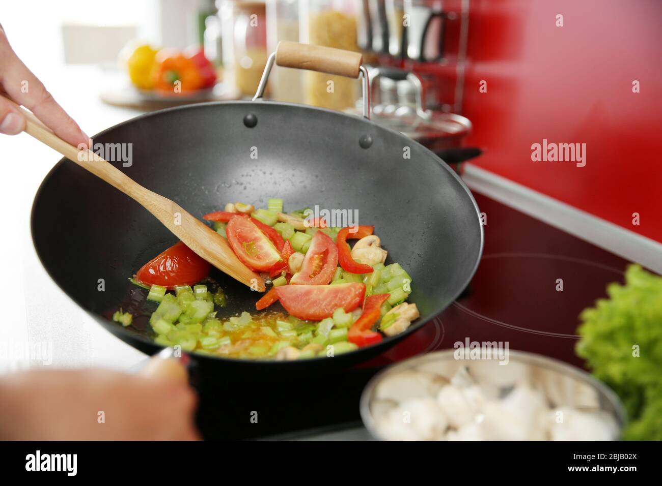 Mixing vegetables in pan closeup Stock Photo - Alamy