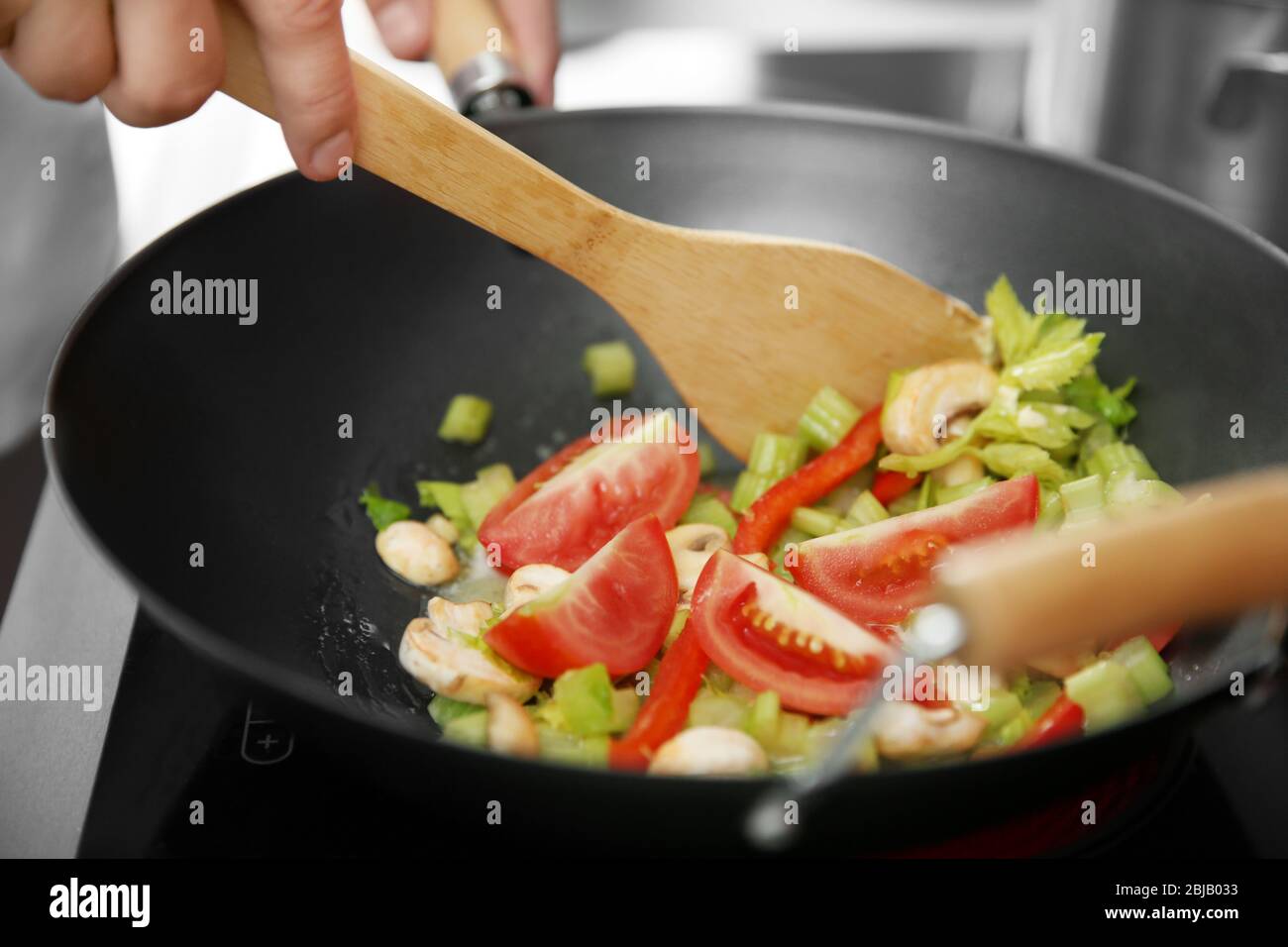 Mixing vegetables in pan closeup Stock Photo - Alamy