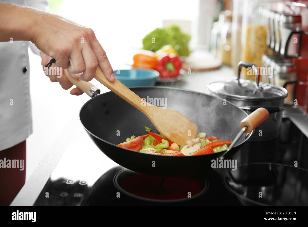 Mixing vegetables in pan closeup Stock Photo - Alamy