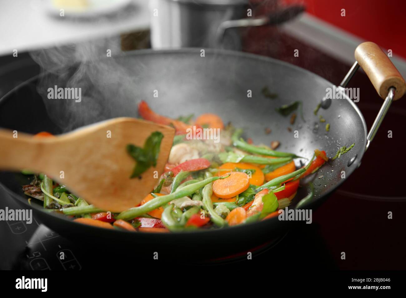 Mixing vegetables in pan closeup Stock Photo - Alamy