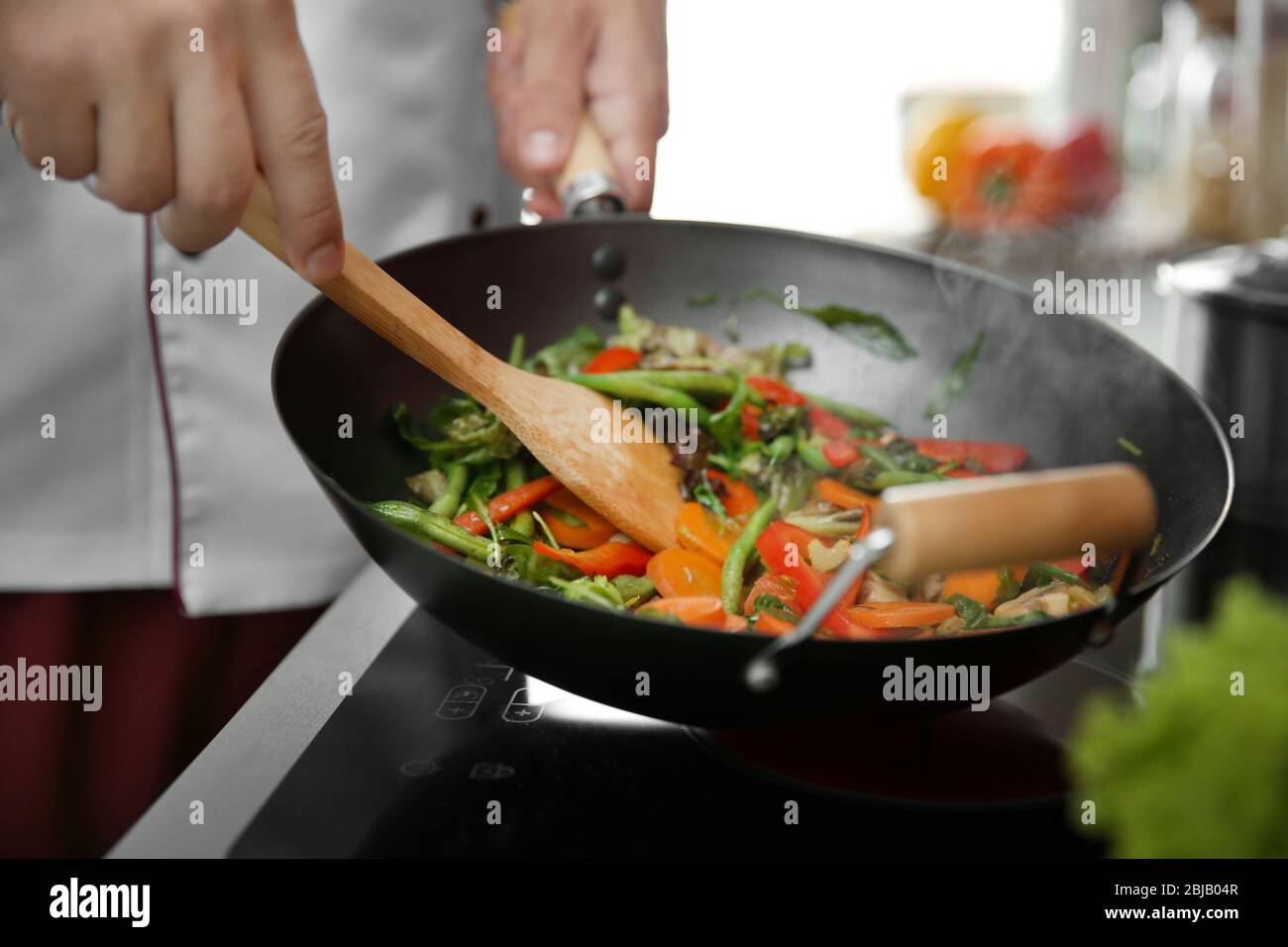 Mixing vegetables in pan closeup Stock Photo - Alamy