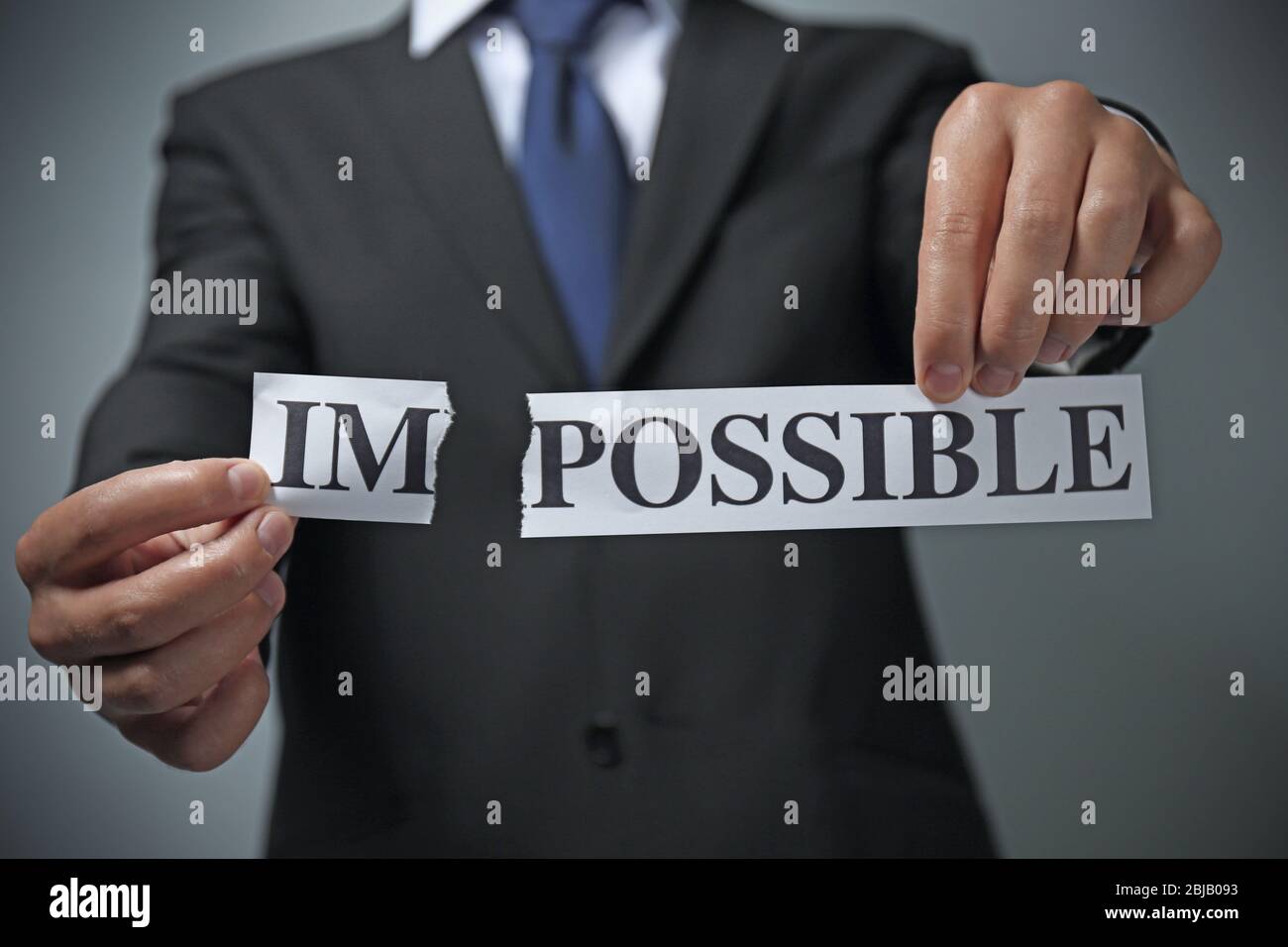 Businessman Tearing Paper With Impossible Word Stock Photo Alamy businessman-tearing-paper-with-impossible-word-stock-photo-alamy