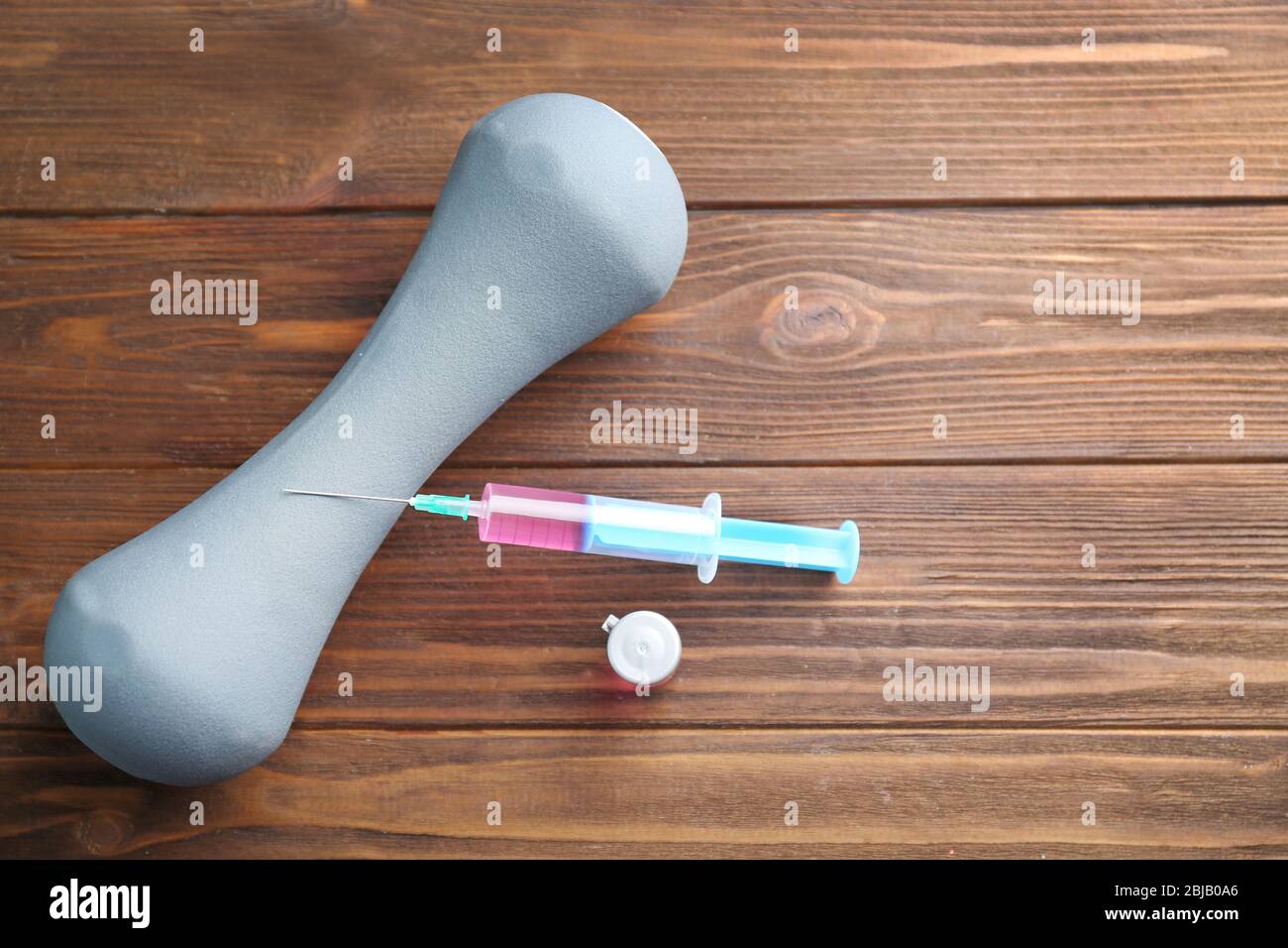 Syringe and dumbbell. Doping in sport concept Stock Photo - Alamy