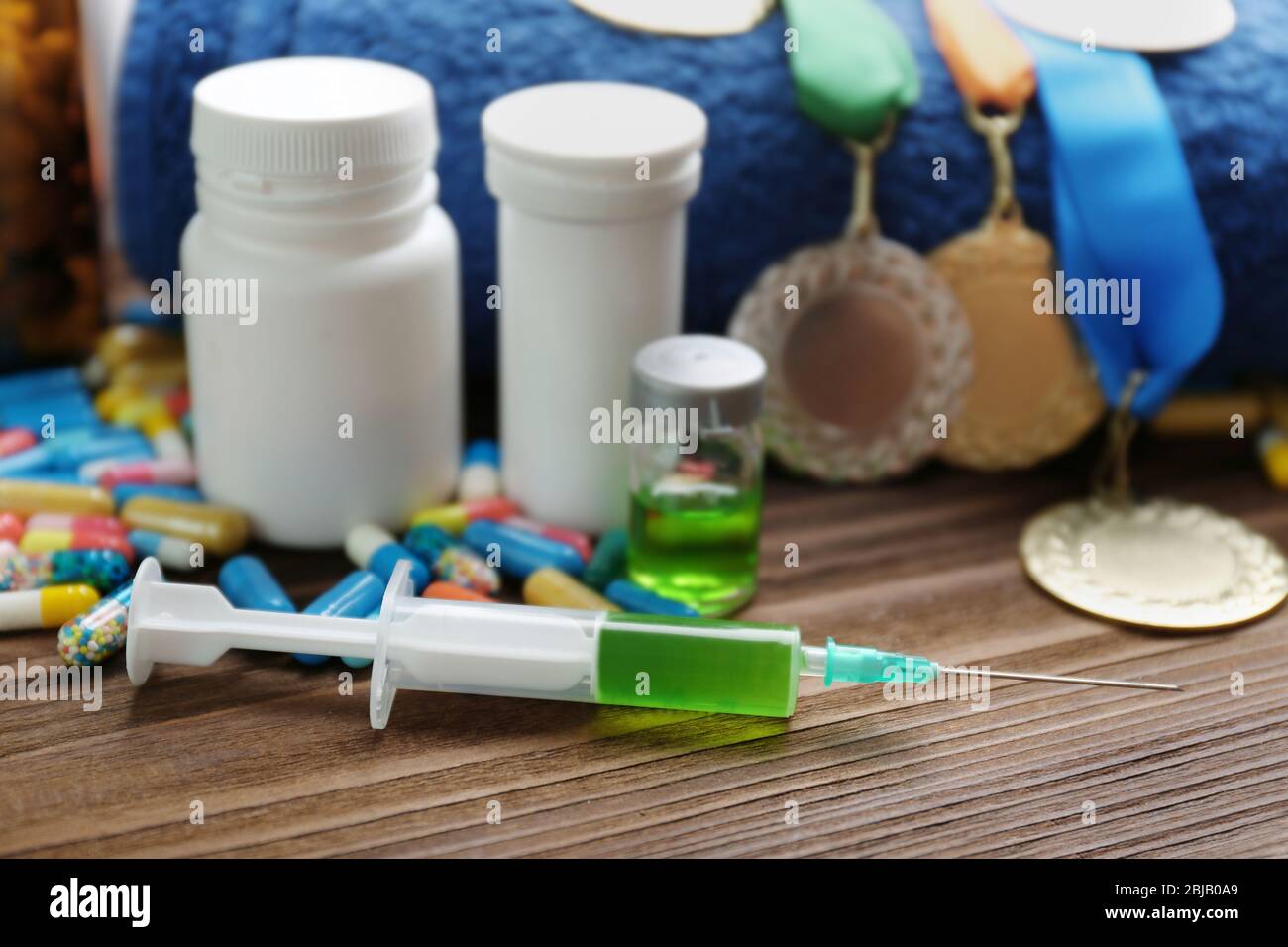 Syringe with pills and medals. Doping in sport concept Stock Photo - Alamy