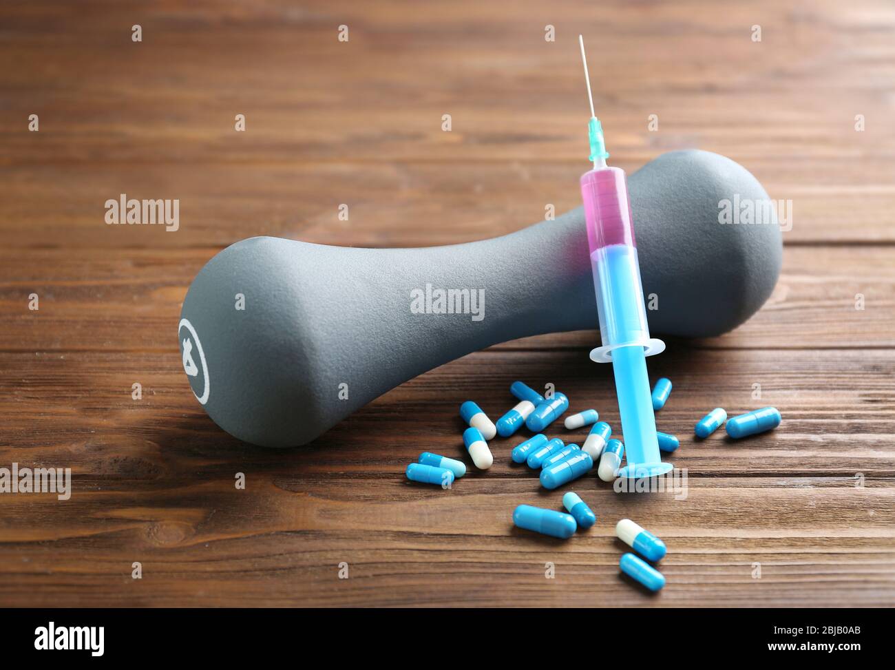 Syringe with pills and dumbbell. Doping in sport concept Stock Photo ...
