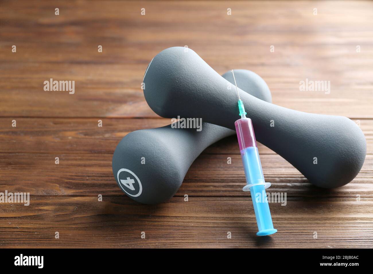 Syringe and dumbbells. Doping in sport concept Stock Photo - Alamy