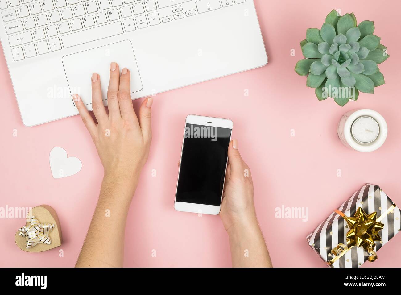 Womens home workspace. Girl Blogger works with phone and laptop ...