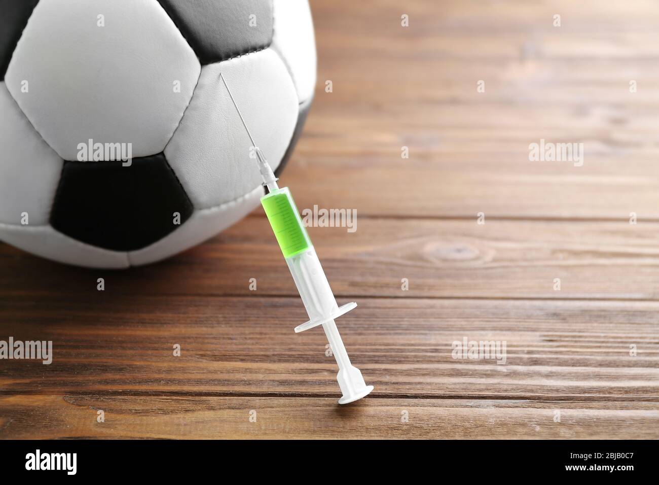 Syringe and soccer ball. Doping in sport concept Stock Photo - Alamy