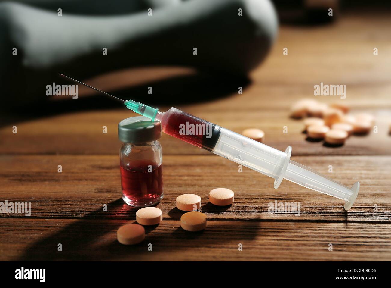 Syringe with pills and dumbbells. Doping in sport concept Stock Photo ...
