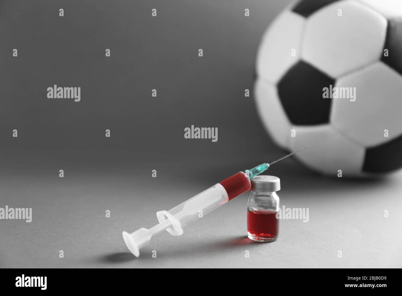 Syringe and soccer ball. Doping in sport concept Stock Photo - Alamy