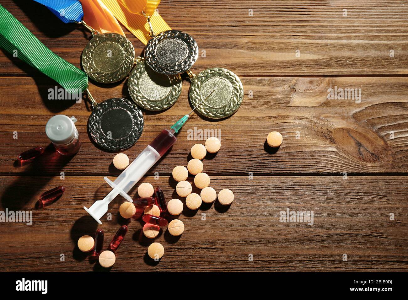 Syringe with pills and medals. Doping in sport concept Stock Photo - Alamy
