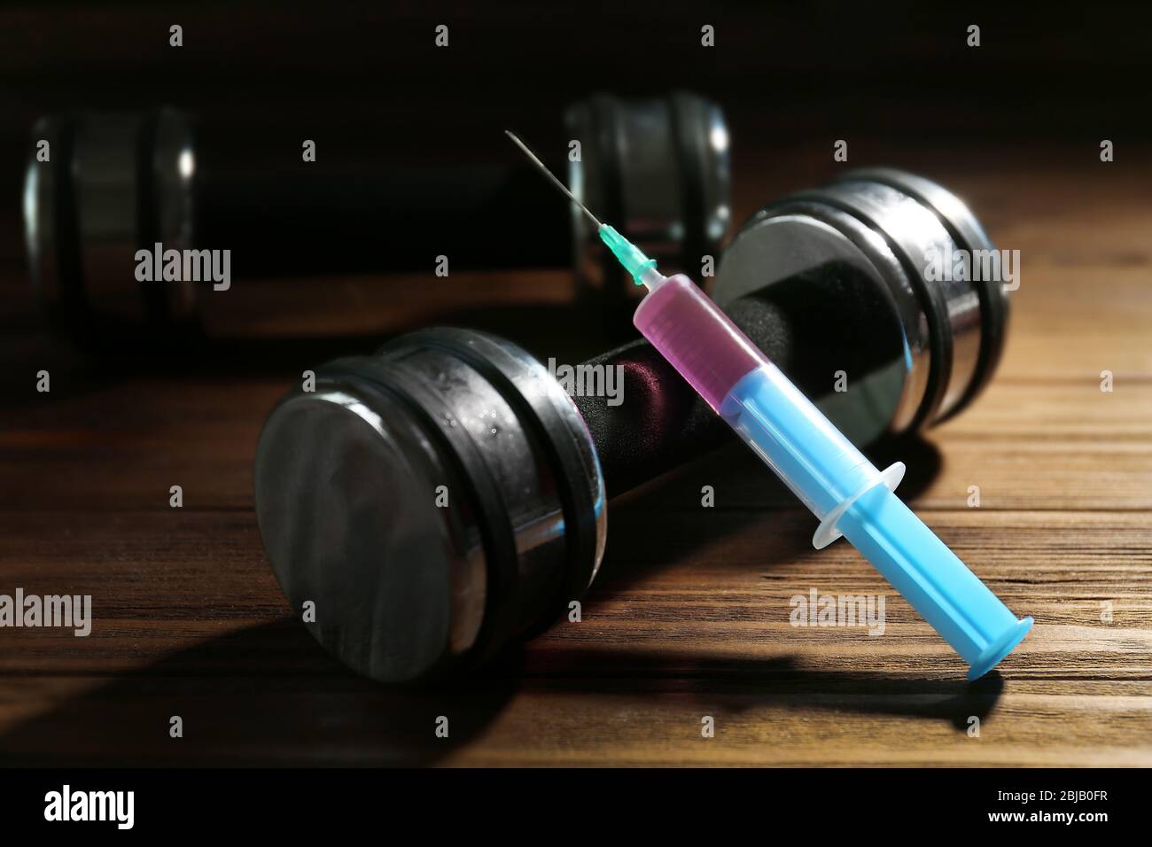 Syringe and dumbbells. Doping in sport concept Stock Photo - Alamy