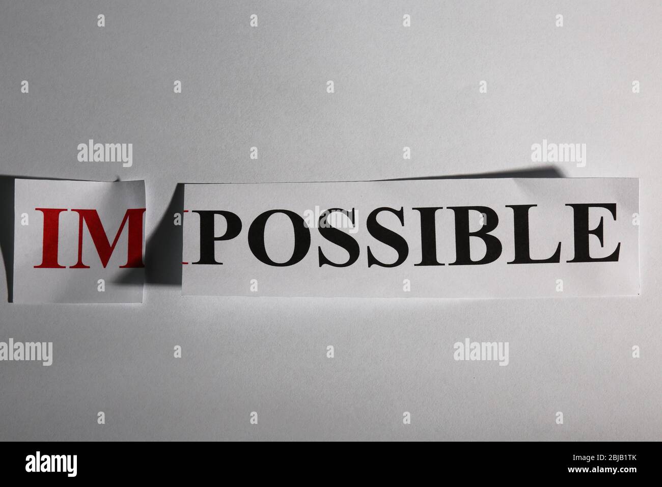 Cut out word IMPOSSIBLE on white background Stock Photo - Alamy