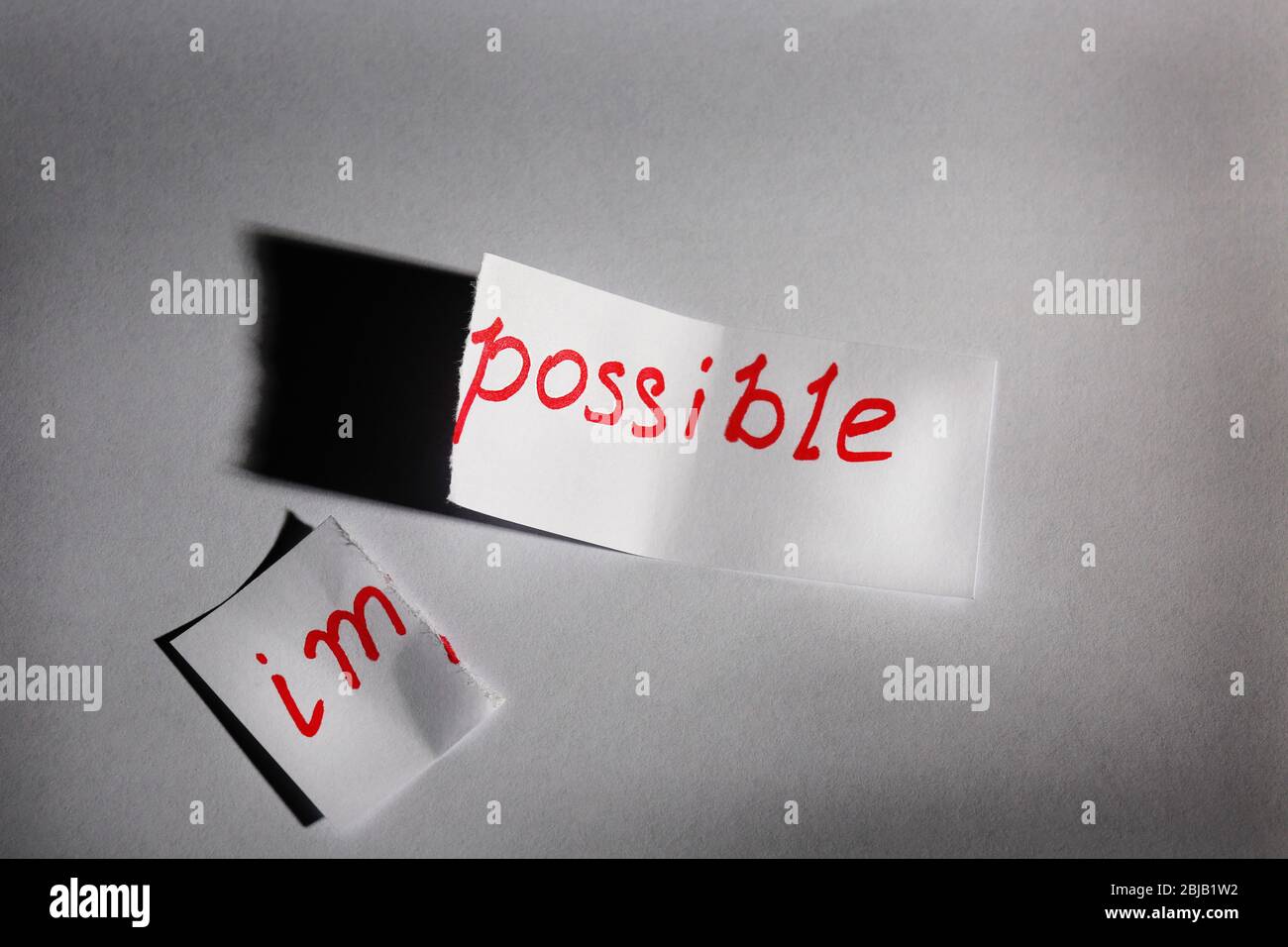 Cut out word IMPOSSIBLE on white background Stock Photo - Alamy