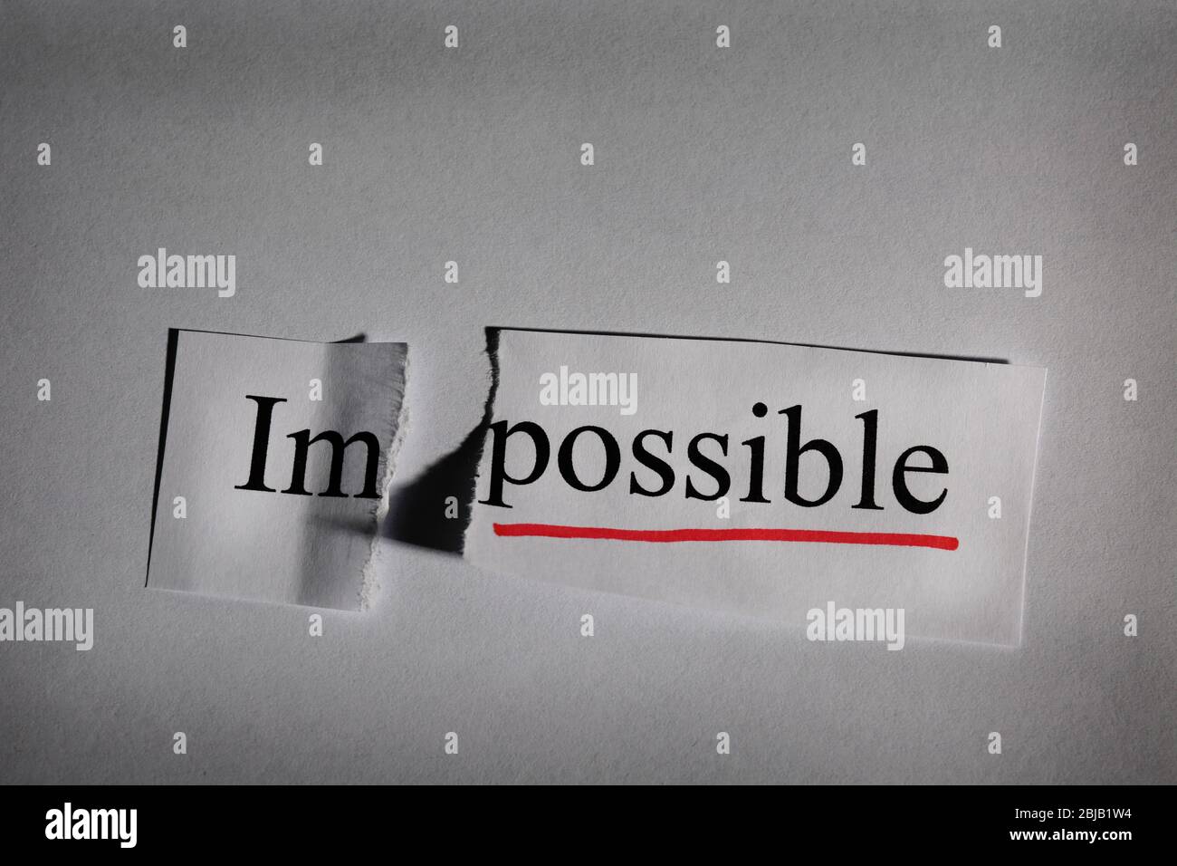 Cut out word IMPOSSIBLE on white background Stock Photo - Alamy
