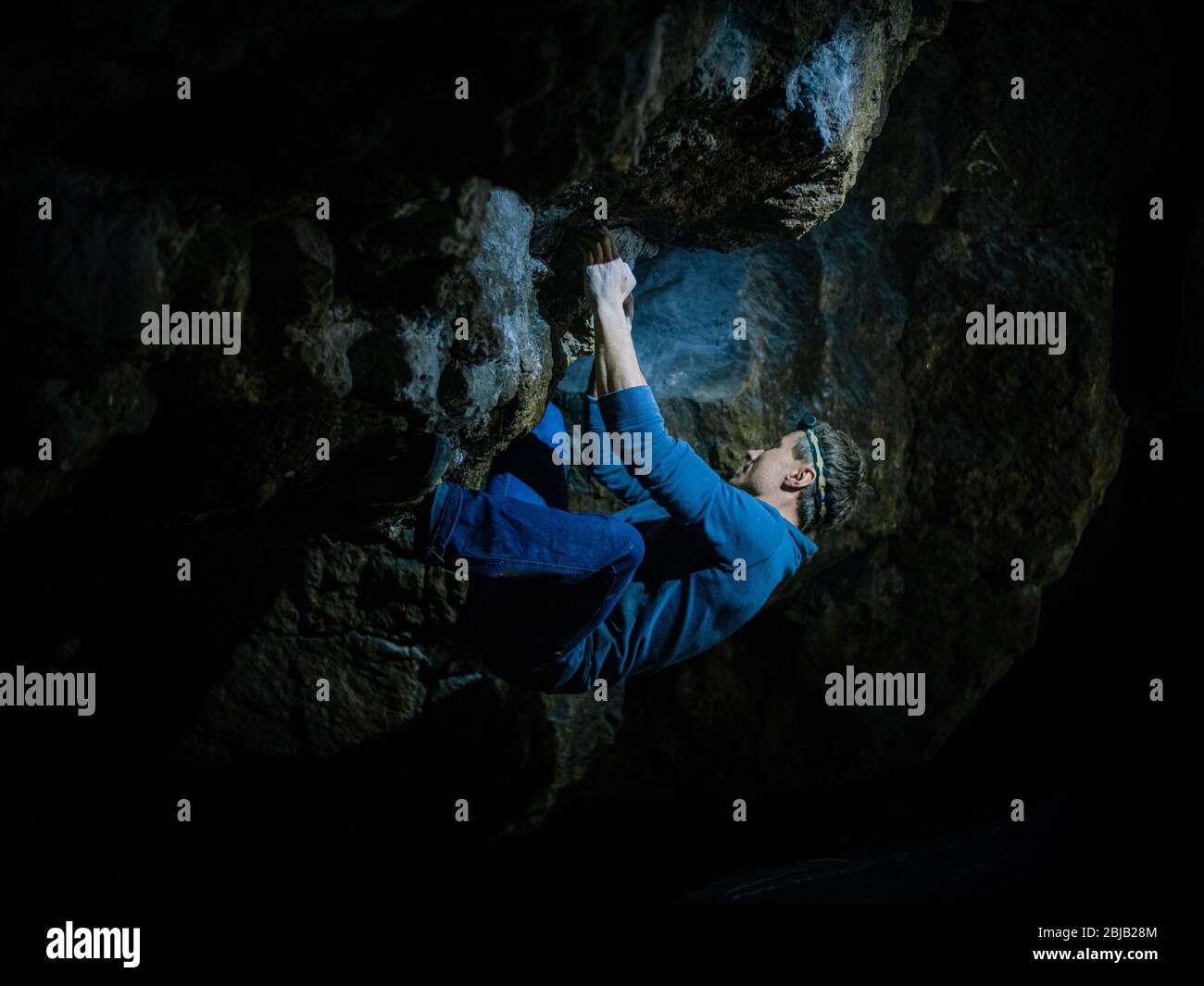 Man is making a boulder in Twardowski cave. Bouldering in rock ...