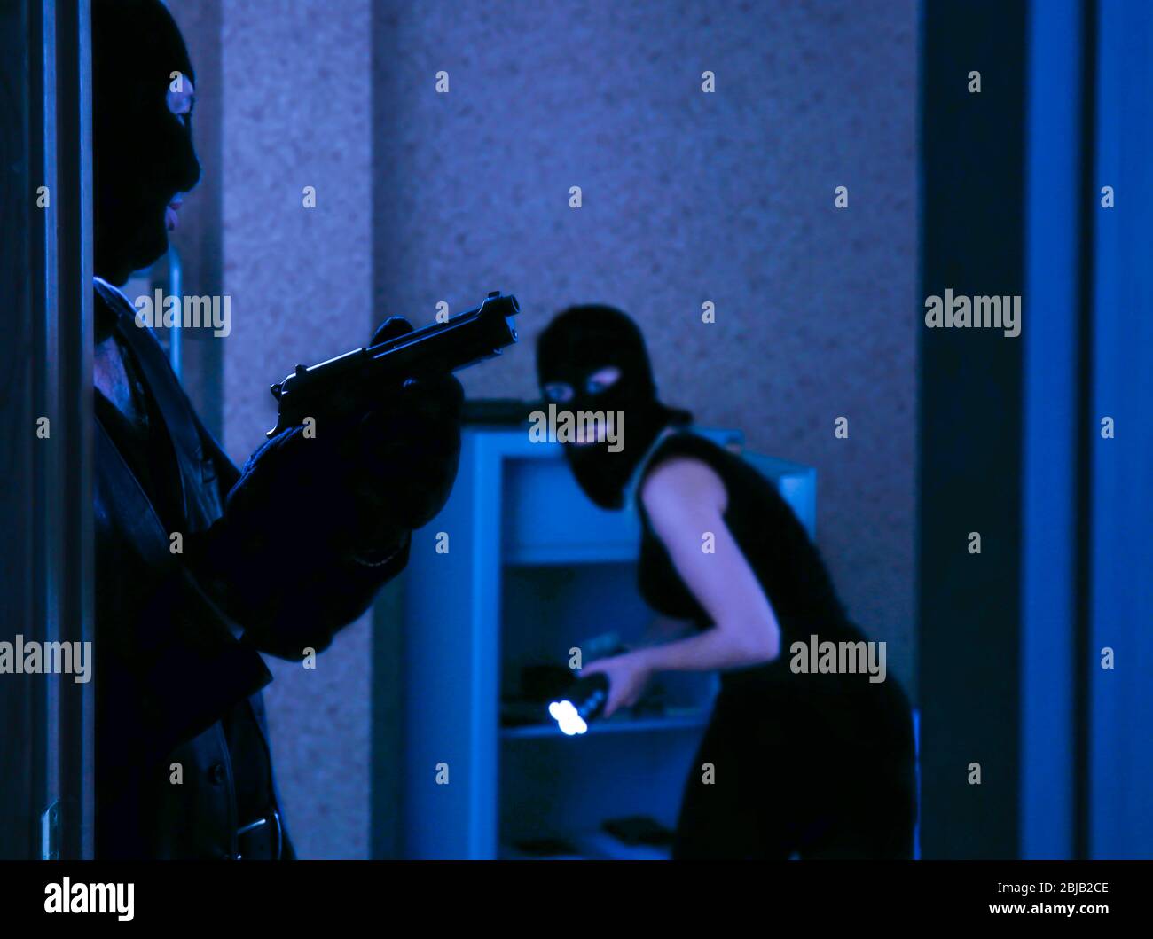 Armed thief entering a house Stock Photo - Alamy