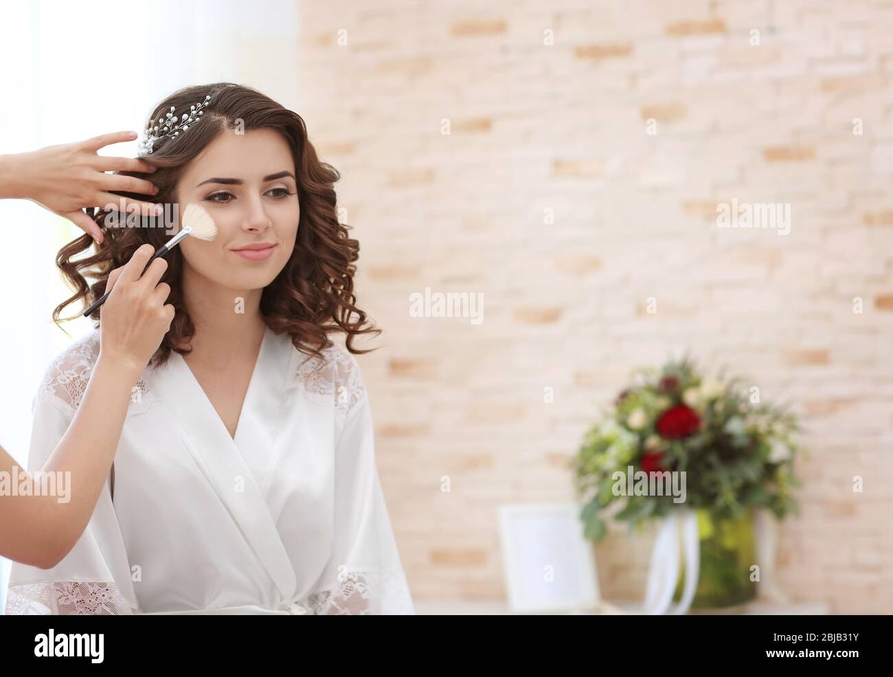 Makeup artist preparing bride before her wedding Stock Photo - Alamy
