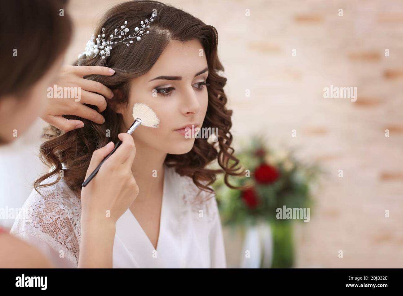 Makeup artist preparing bride before her wedding Stock Photo - Alamy