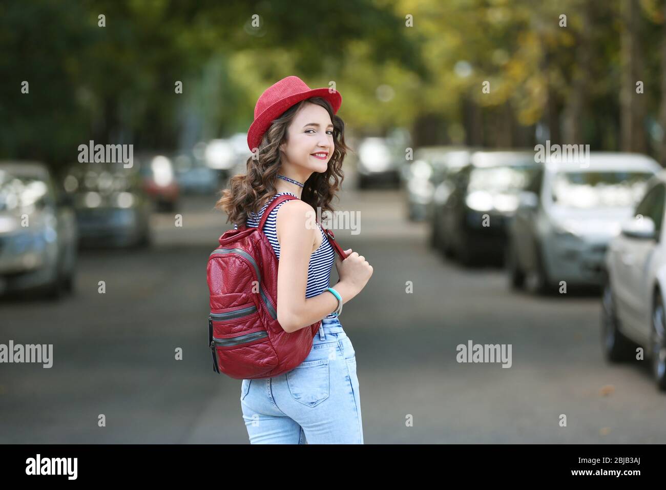Beautiful young girl standing on road Stock Photo - Alamy
