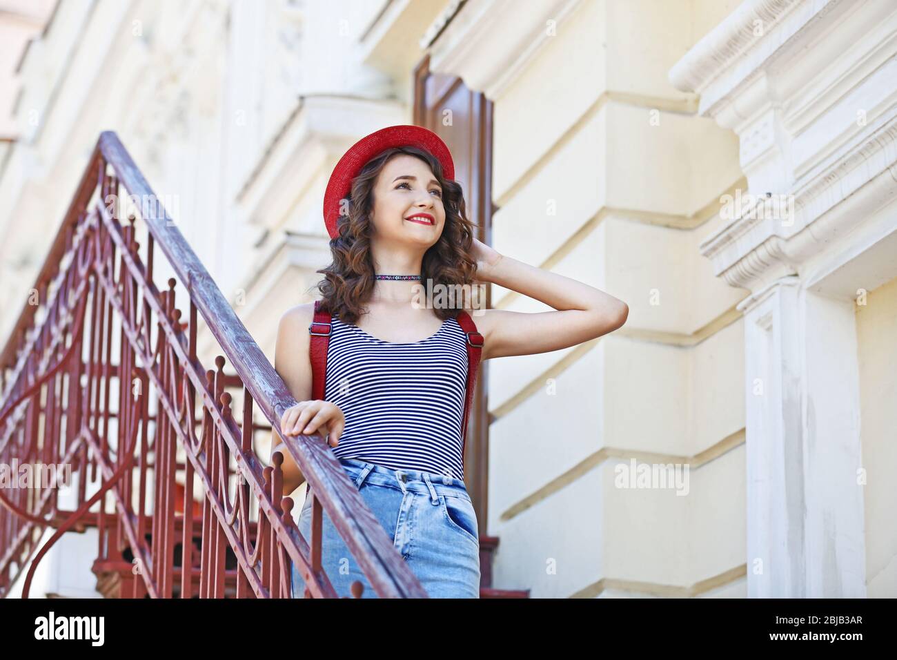 Beautiful young girl standing on stairs Stock Photo - Alamy