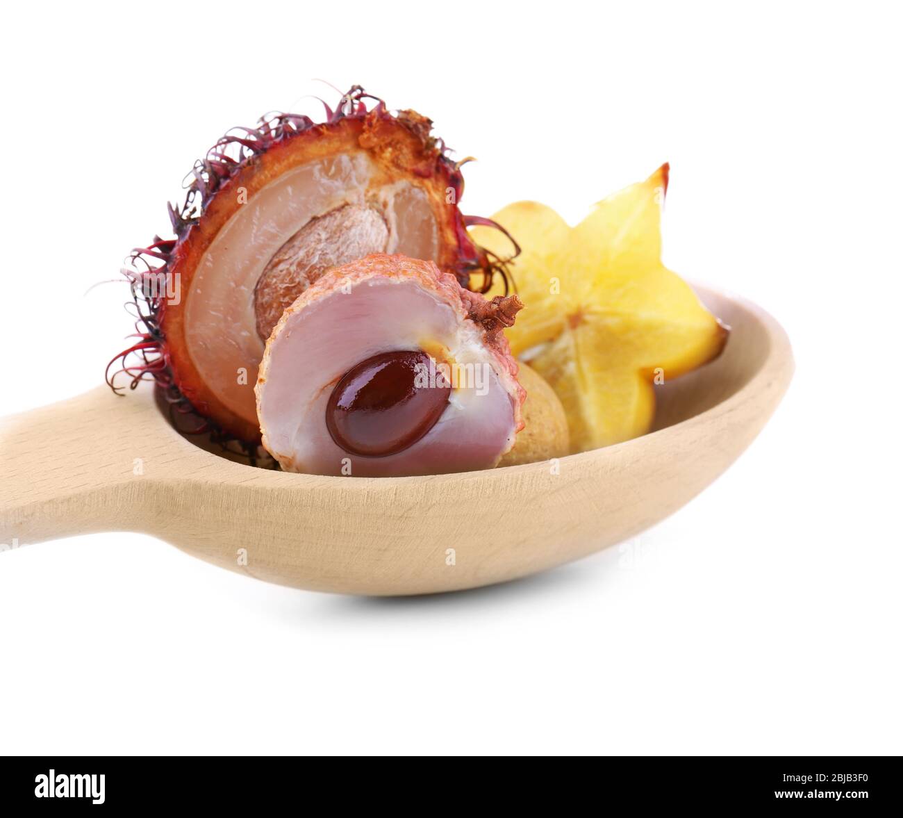 Exotic fruits in wooden spoon isolated on white Stock Photo - Alamy