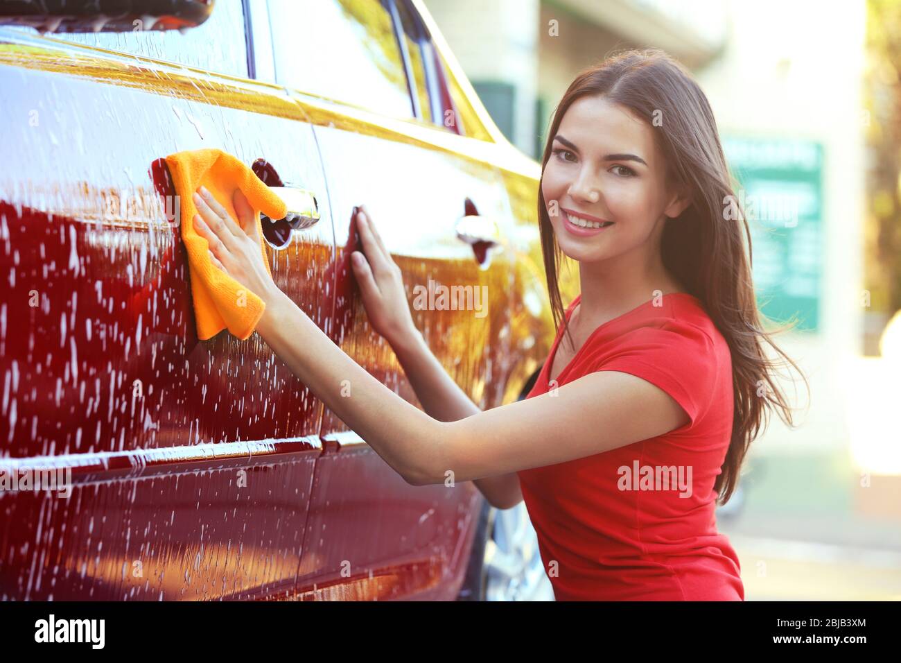Woman washing a car Stock Photo - Alamy