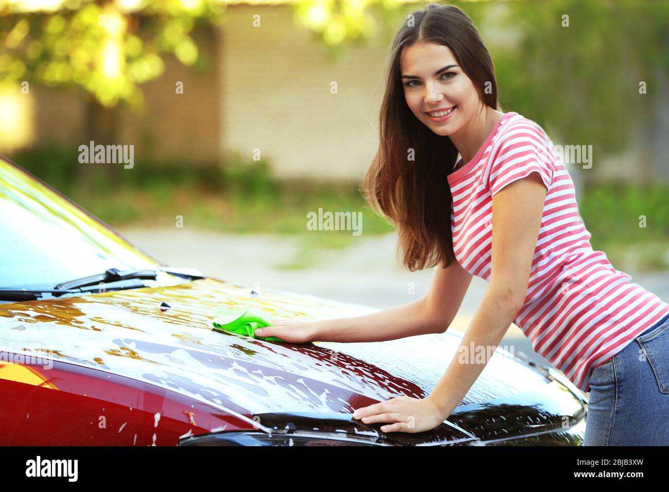 Woman washing a car Stock Photo - Alamy