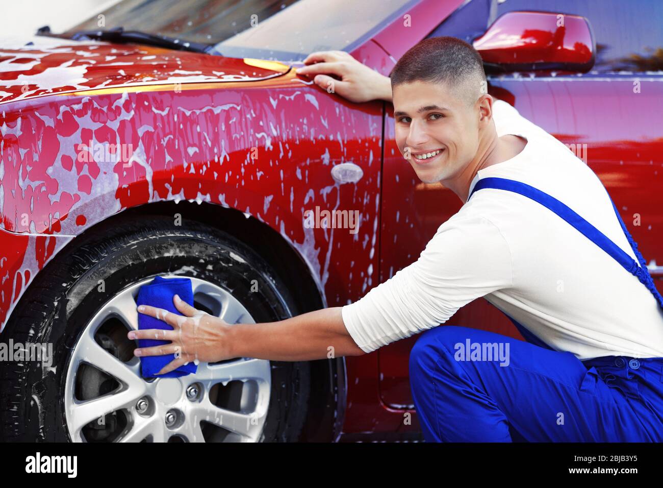 Serviceman washing a car Stock Photo - Alamy